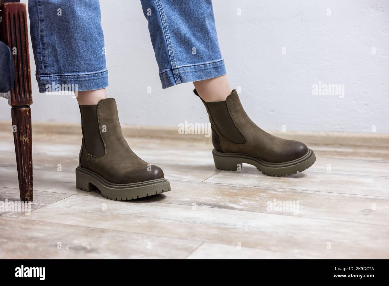 Beautiful female legs in leather boots and jeans. Female legs in ...