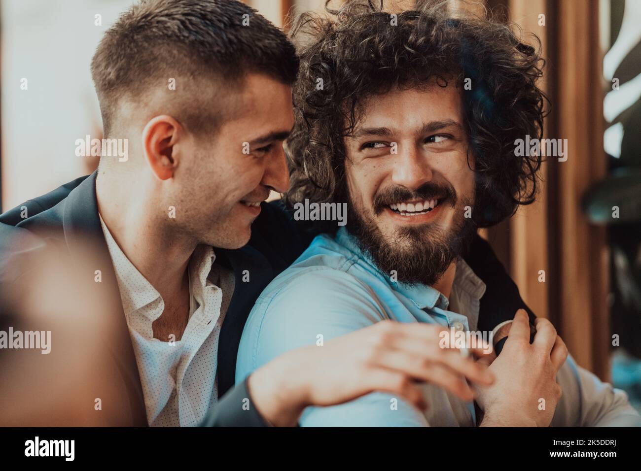 Portrait of multiethnic diverse gay LGBT romantic male couple embracing ...