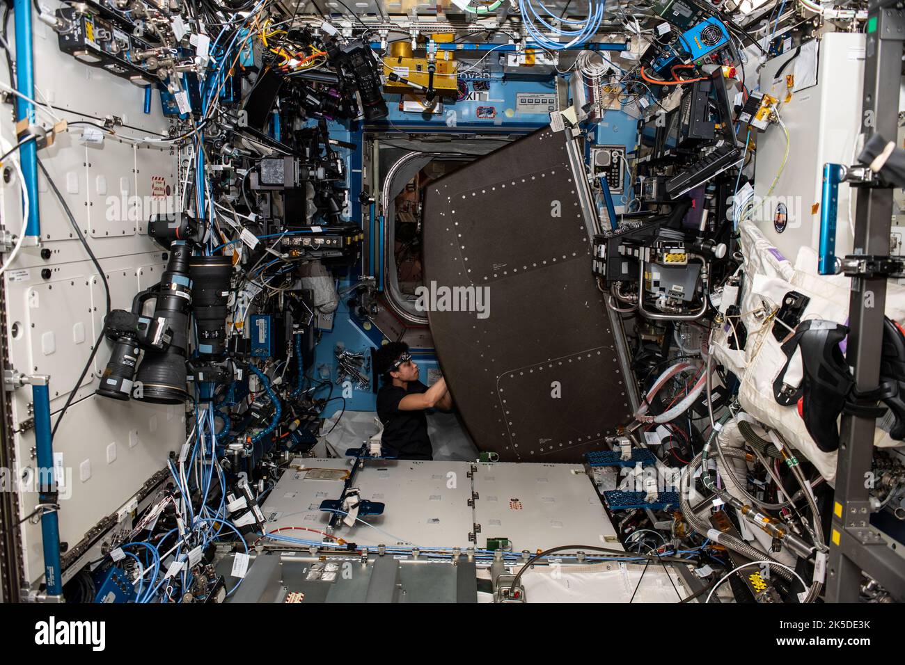 NASA astronaut Jessica Watkins of Expedition 67 services the Major Constituents Analyzer in the ...