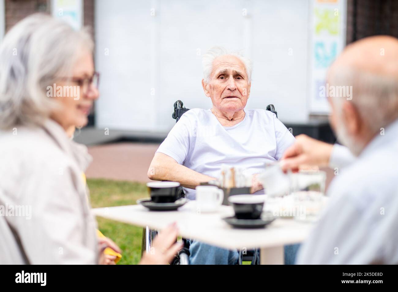 Group of happy elderly people bonding outdoors at the bar cafeteria ...
