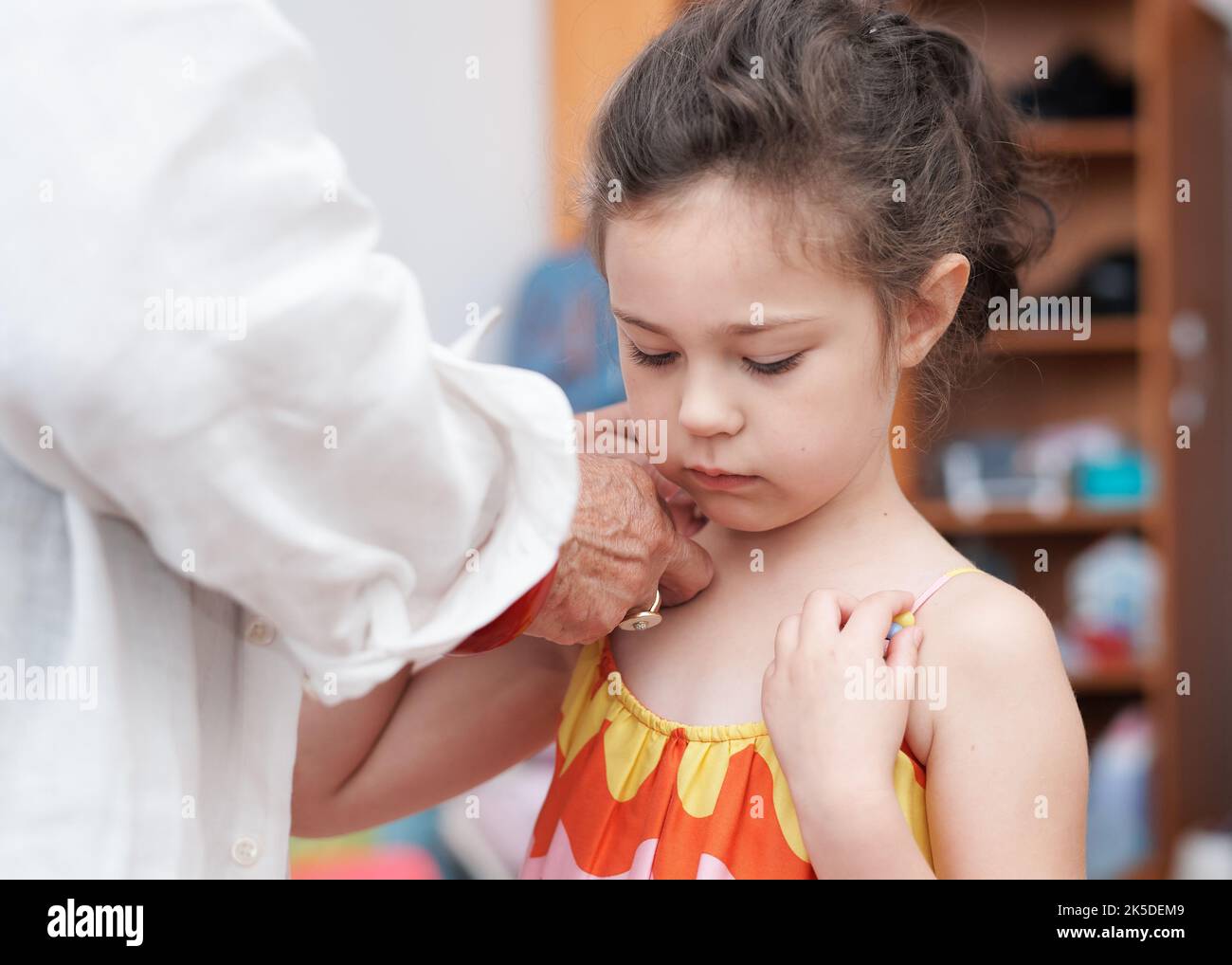 pretty girl trying on summer outfits with grandmother Stock Photo - Alamy