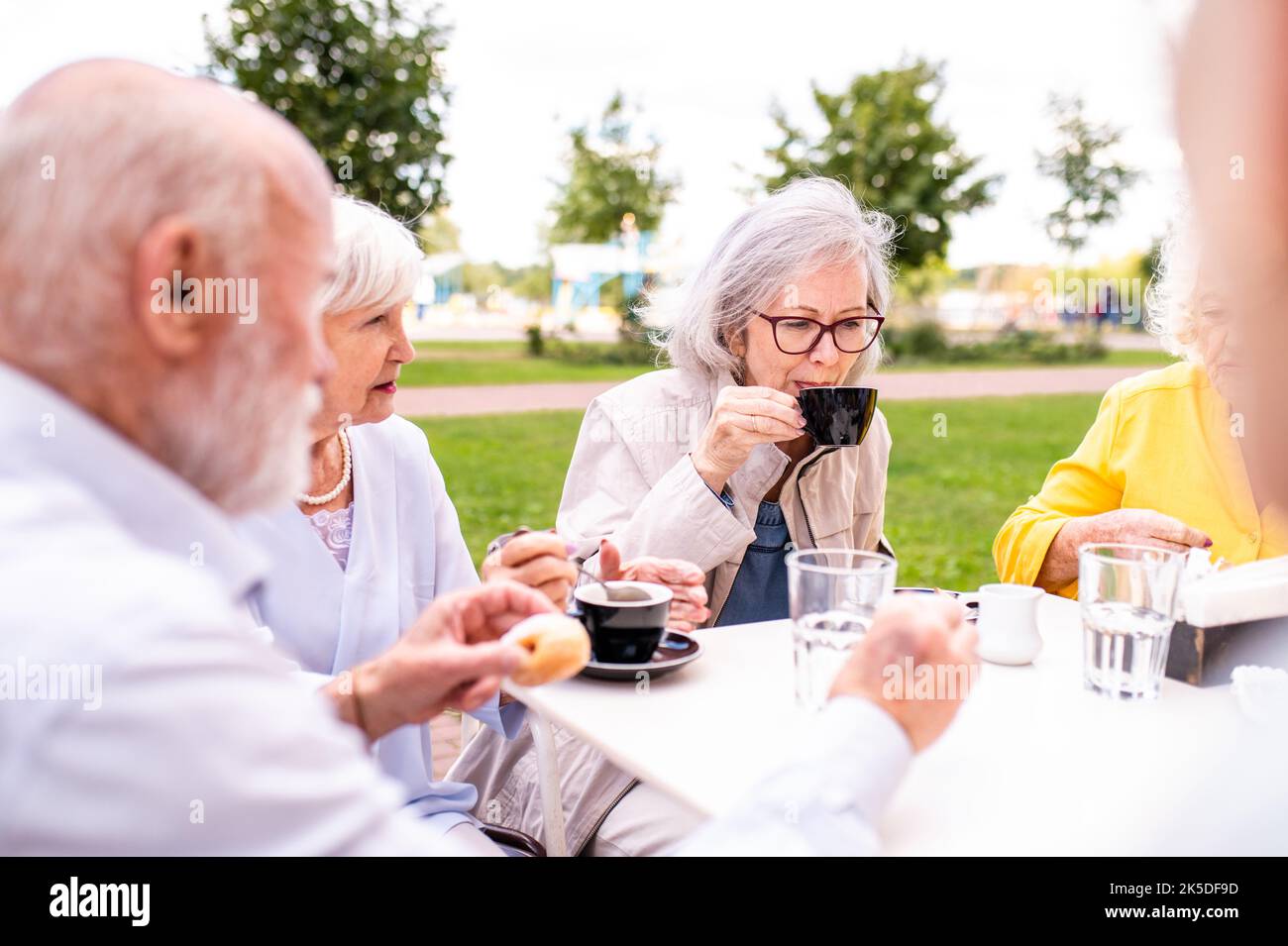 Group of happy elderly people bonding outdoors at the bar cafeteria ...