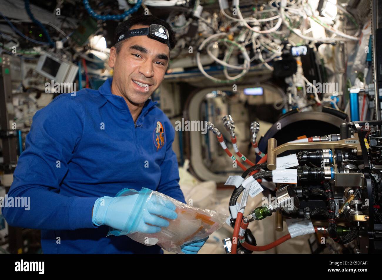 NASA astronaut and Expedition 66 Flight Engineer Raja Chari replaces hardware inside the ...
