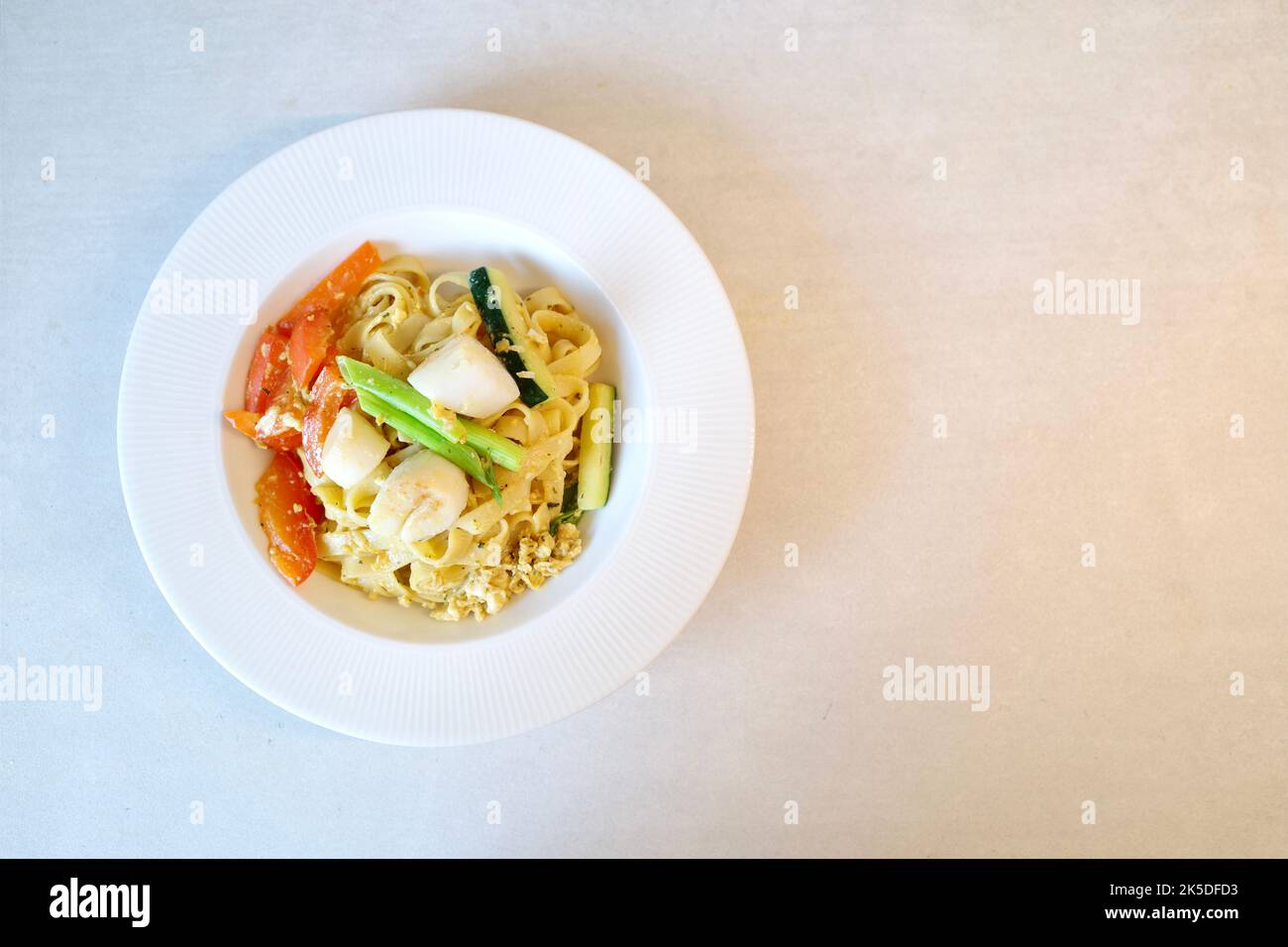 Fried noodles with scallops and vegetables. It’s a common homemade ...