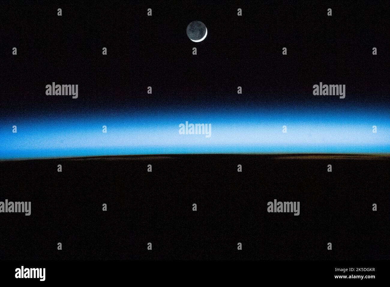 The waxing crescent Moon is pictured above Earth's atmosphere ...