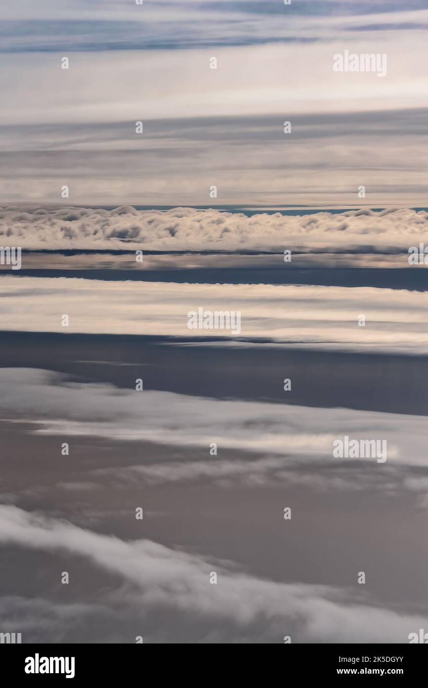 A vertical shot of the stacks of clouds and the sun seen from an ...