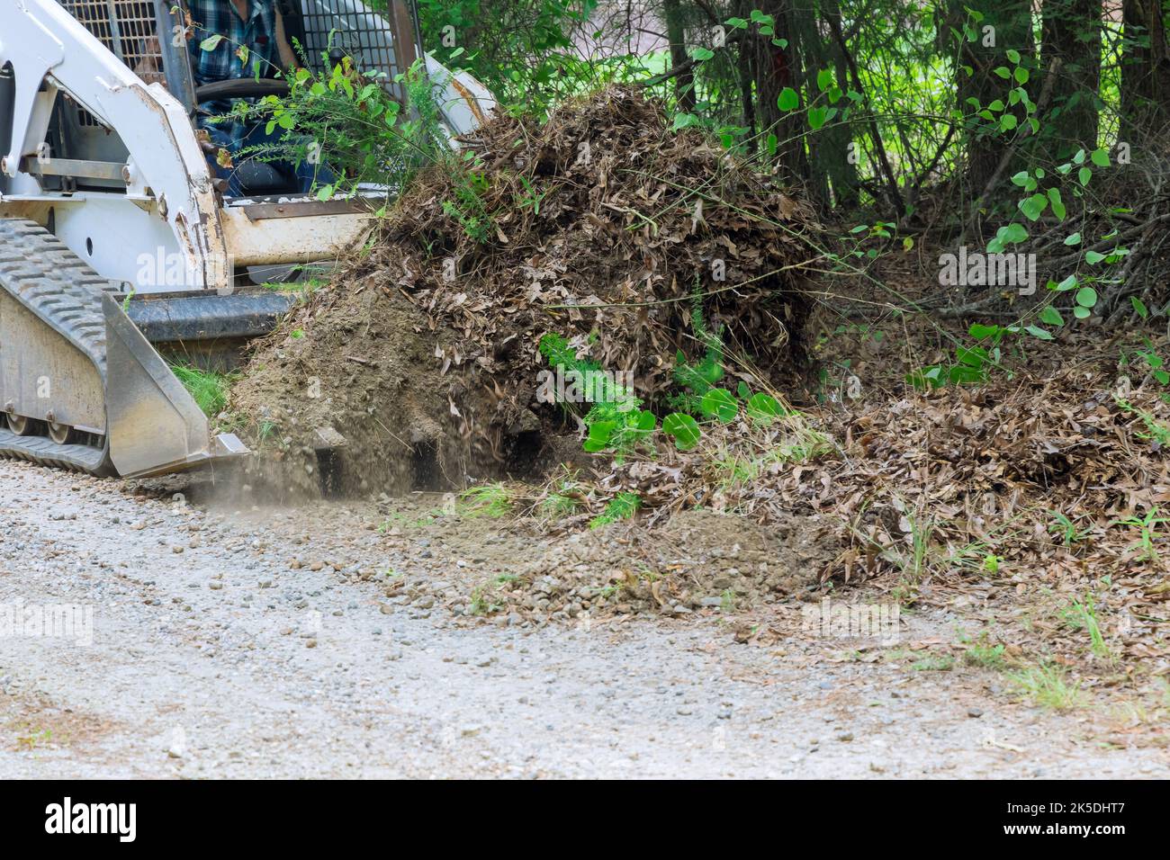 Landscaping works bulldozer using the scoop to move earth Stock Photo ...