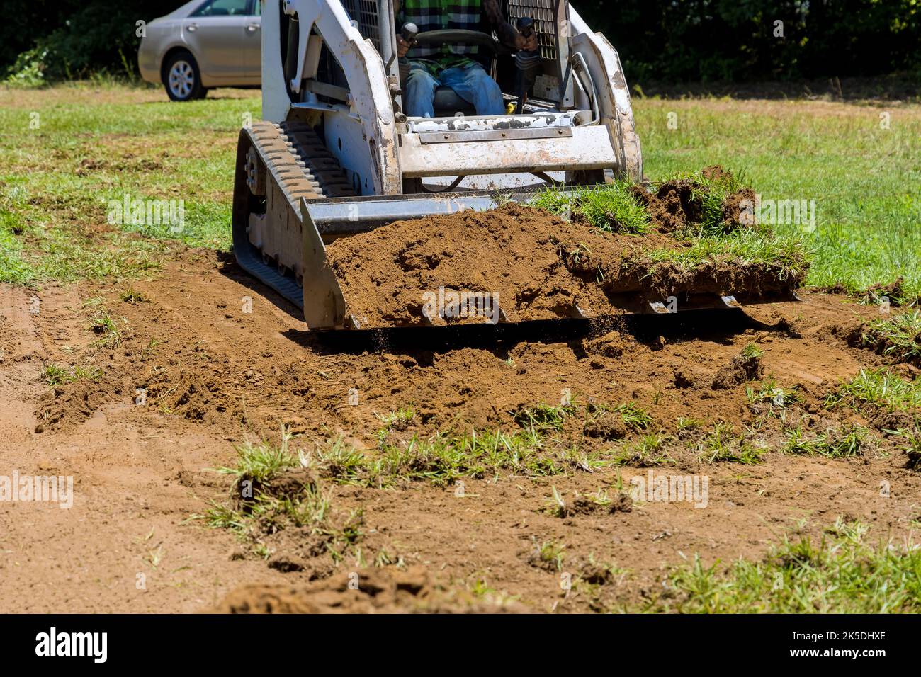 Landscape works bulldozer using scoop to move earth in landscape work ...