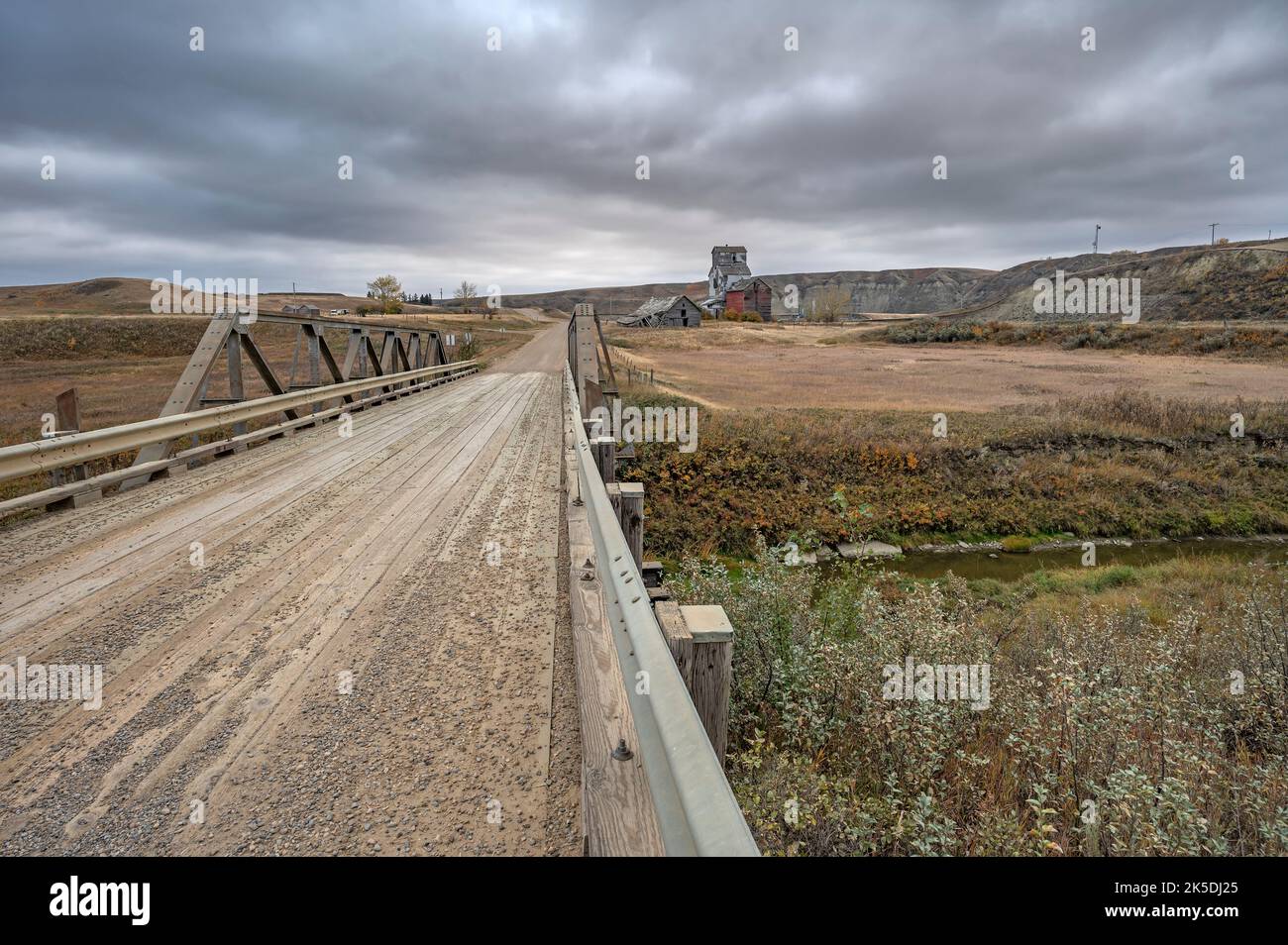Road with distant ruins of the former town of Sharples, Alberta Stock ...