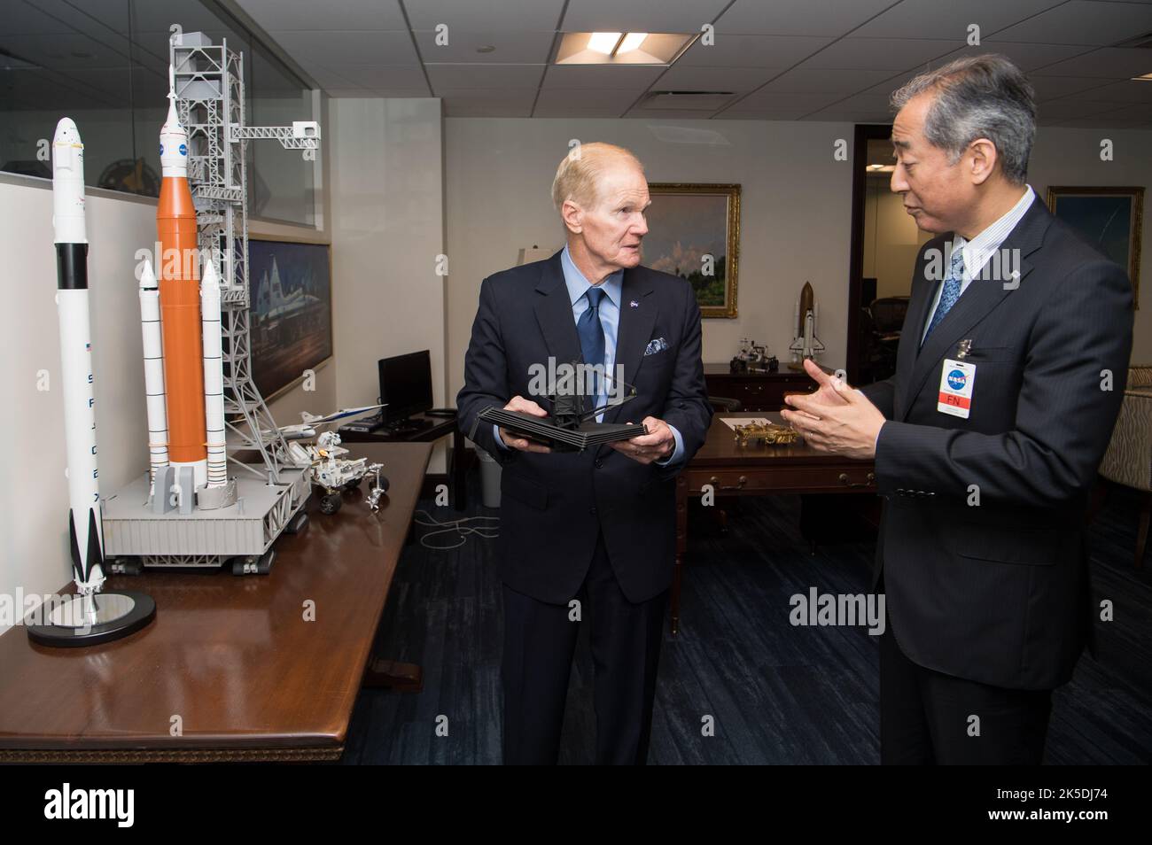 NASA Administrator Bill Nelson, left, shows some of the models of ...