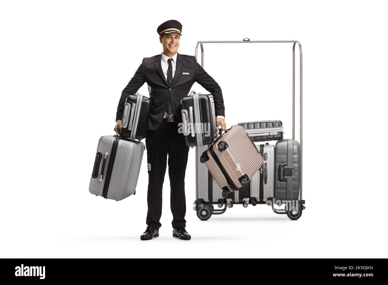 Bellboy holding many suitcases and standing in front of a hotel luggage ...