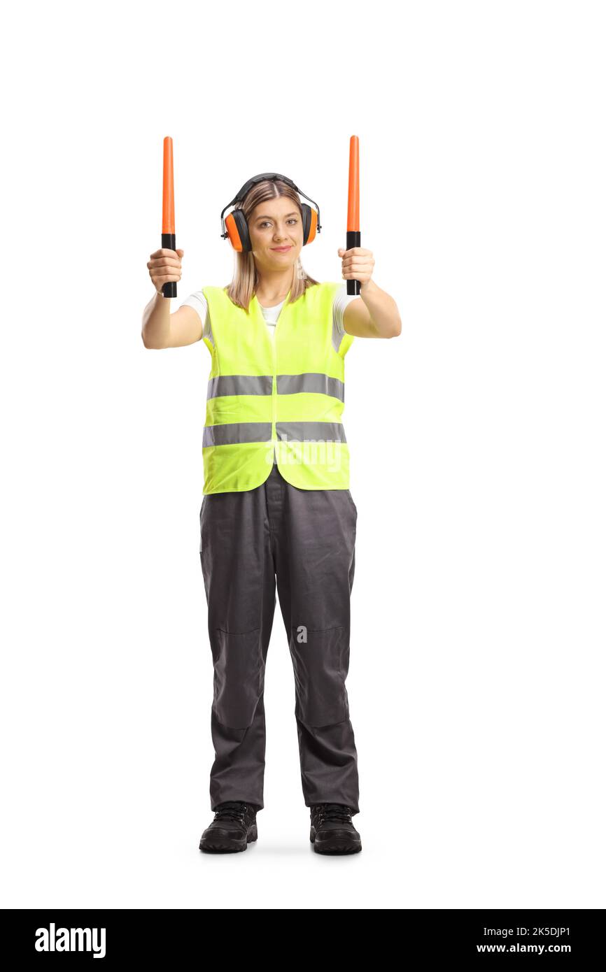 Full length pоrtrait of a female aircraft marshaller with wands ...