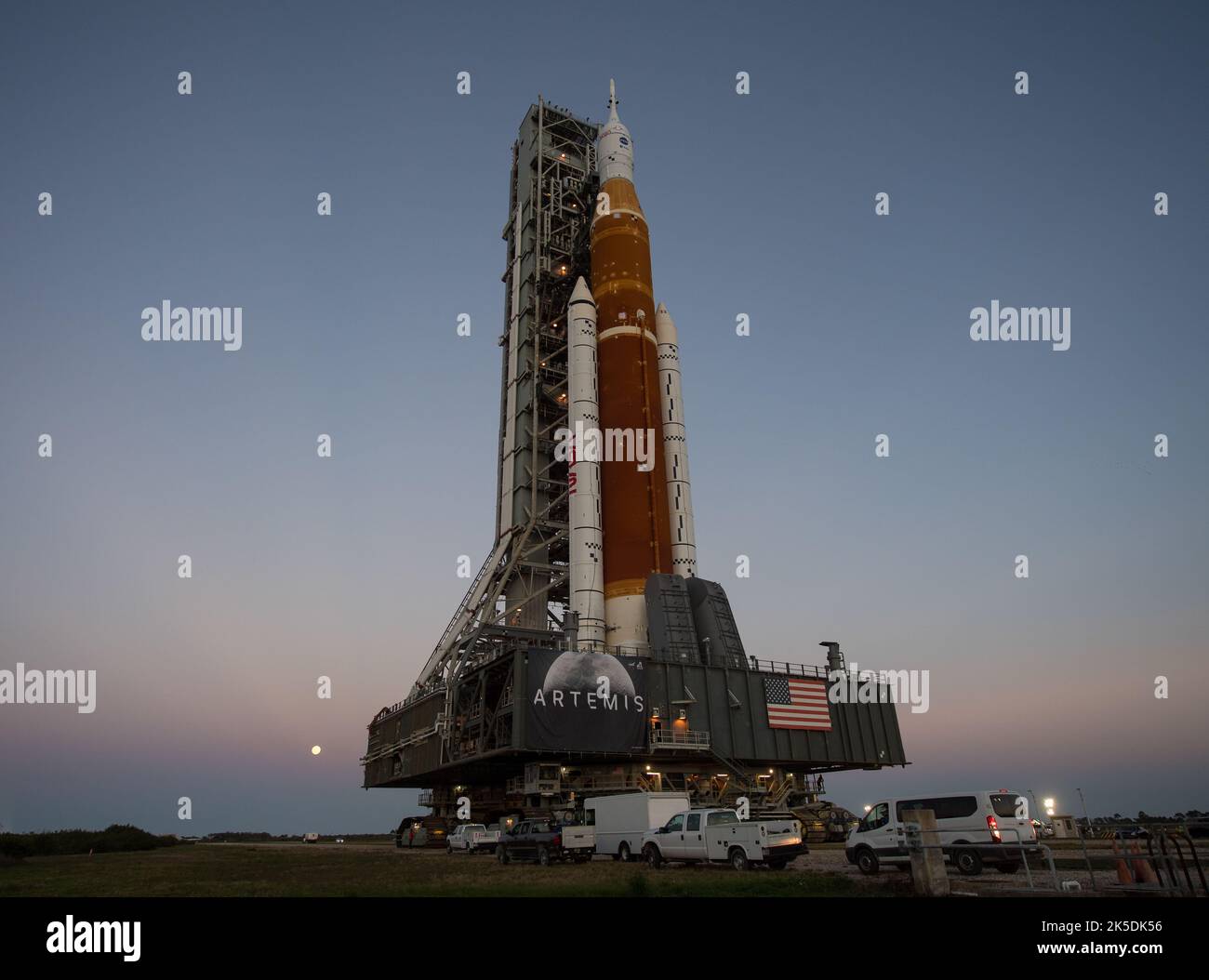 The Moon is seen rising behind NASA’s Space Launch System (SLS) rocket ...