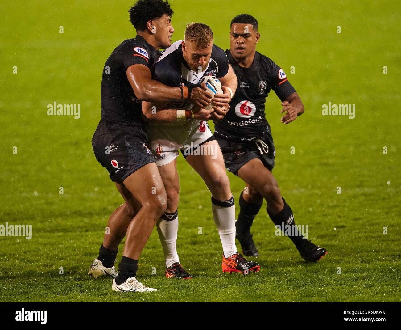 England's Luke Thompson (centre) is tackled by Fiji's Josh Wong (left ...