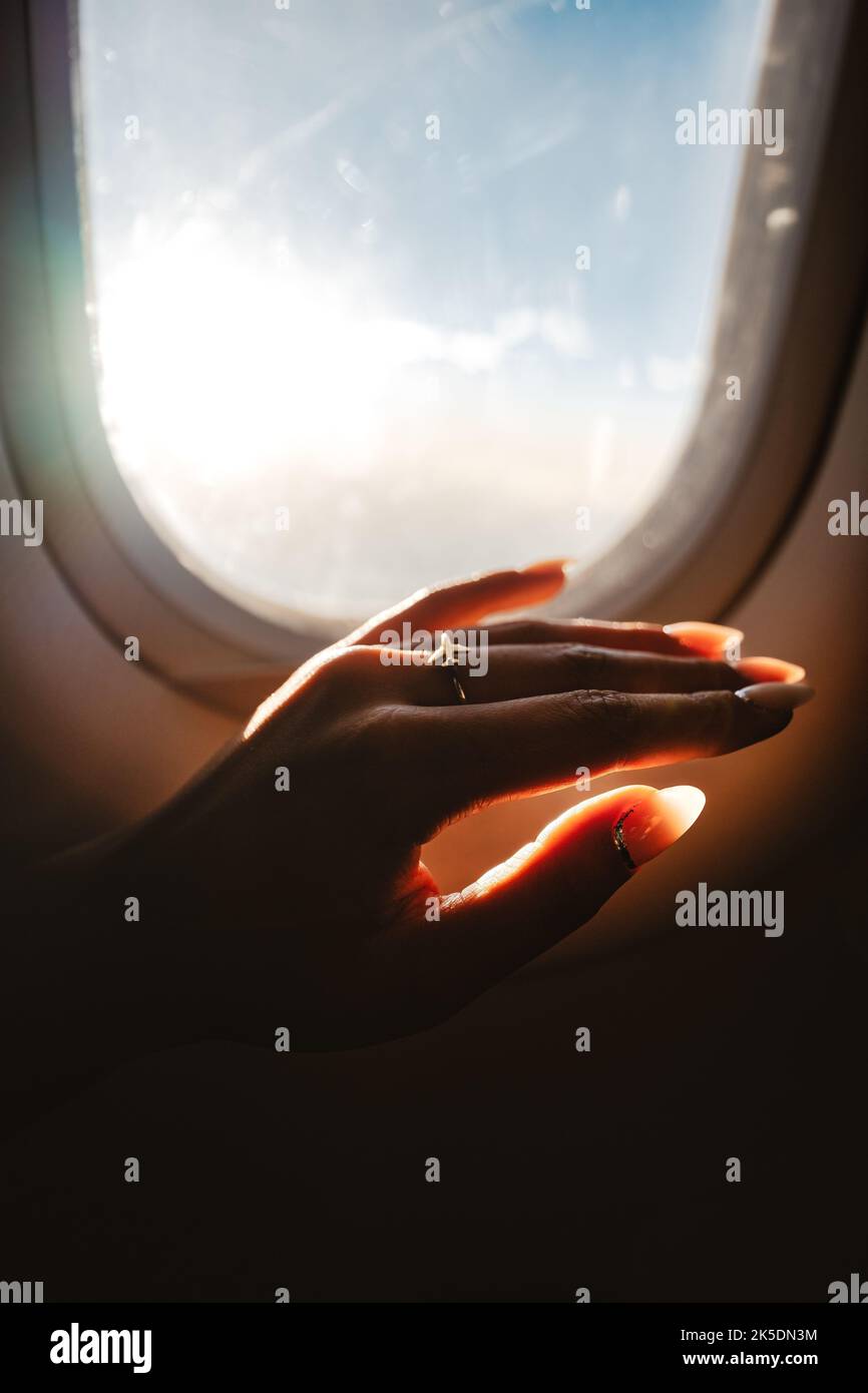 A vertical closeup of a female hand with a plane ring on the ring ...