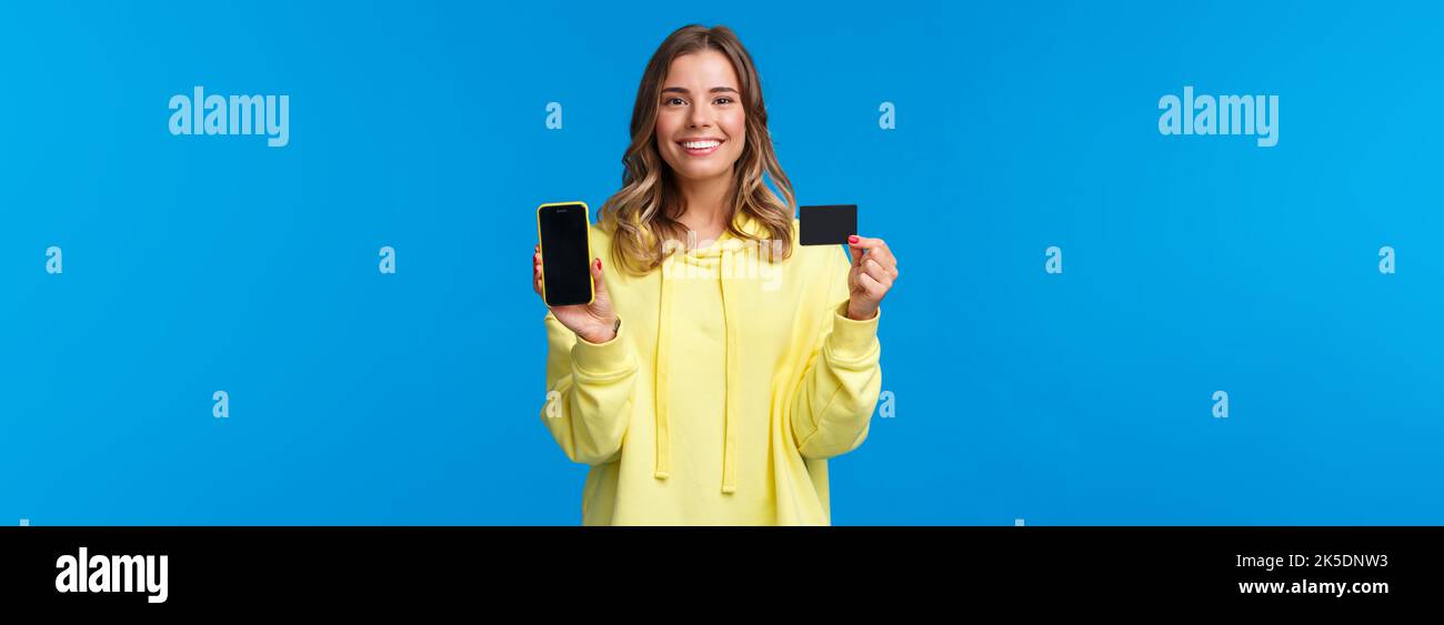 Banking and finance concept. Portrait of happy smiling blond young girl ...