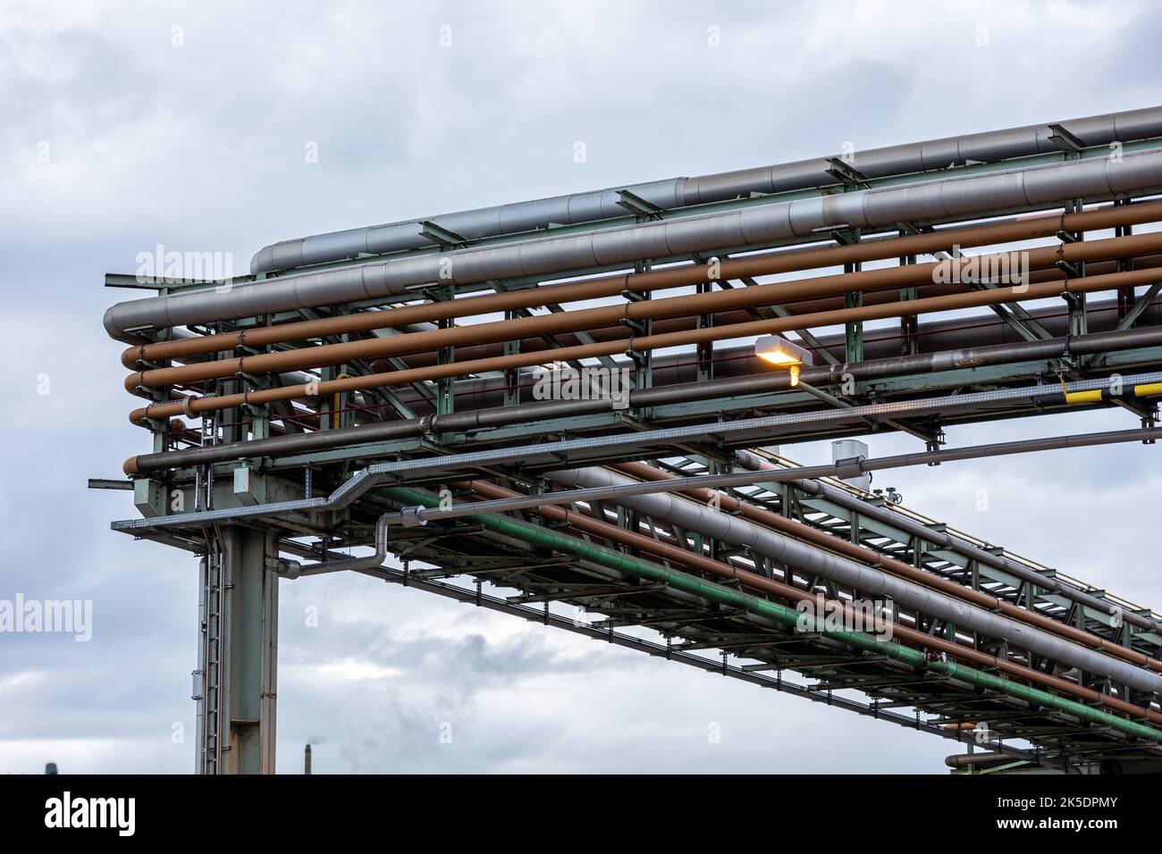 The pipelines of a German factory under the cloudy sky Stock Photo - Alamy