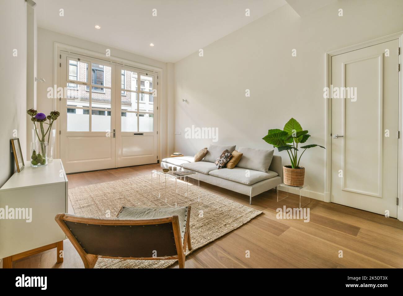 Table with chairs and flowers located near lounge area and kitchen in ...