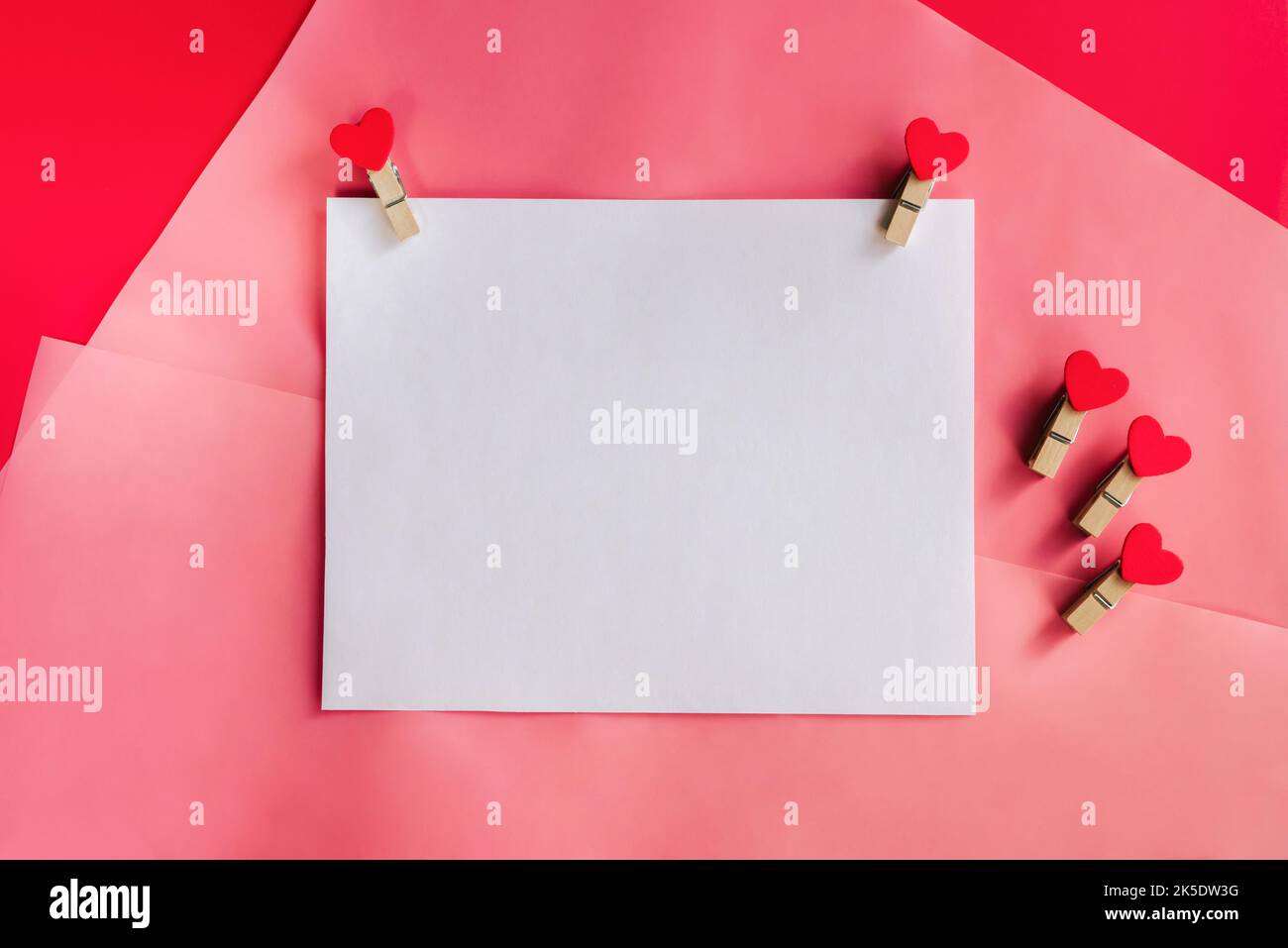 Blank greeting card with pins hearts on red and pink background. Mockup ...