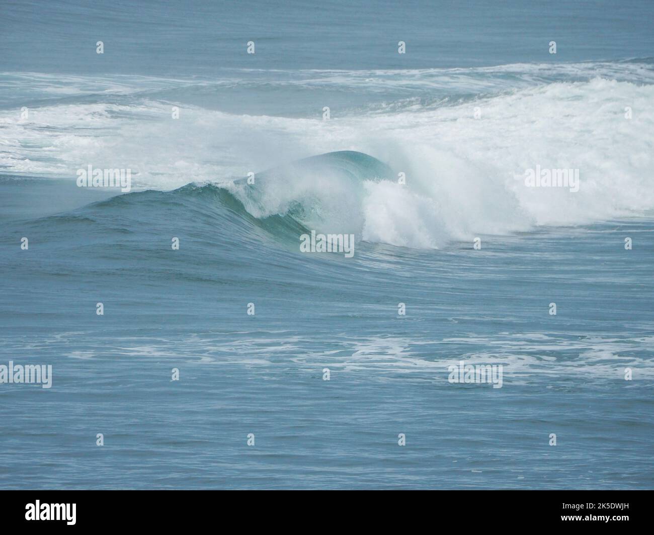 A line of waves crashing in and breaking at an Australian east coast ...