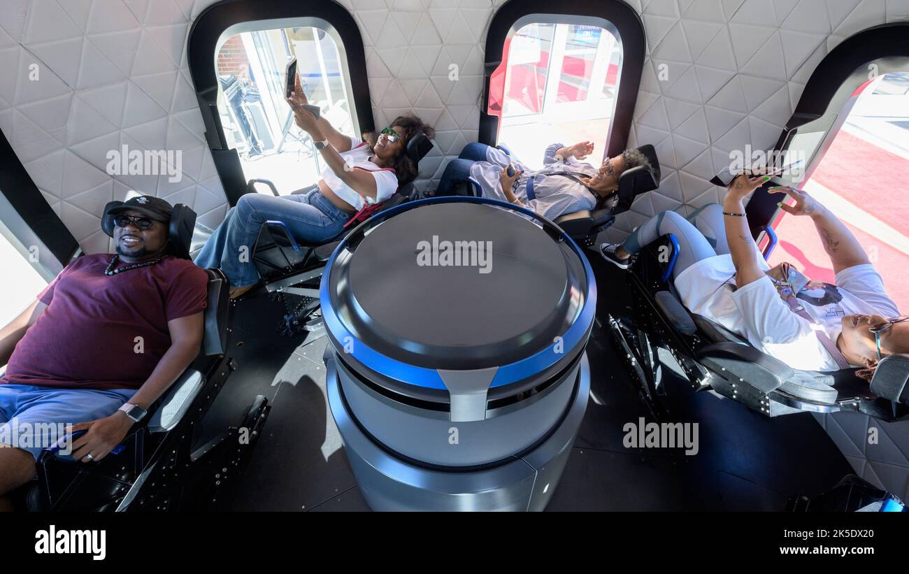 Attendees experience the inside of a Blue Origin New Shepard capsule mockup prior to the ...