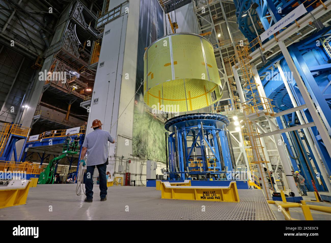 Technicians at NASA’s Michoud Assembly Facility move the engine section ...