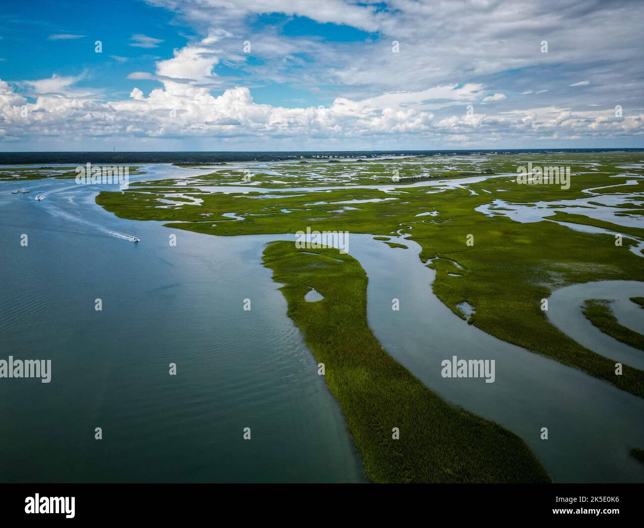 An aerial view of a marshland under a blue cloudy sky Stock Photo - Alamy
