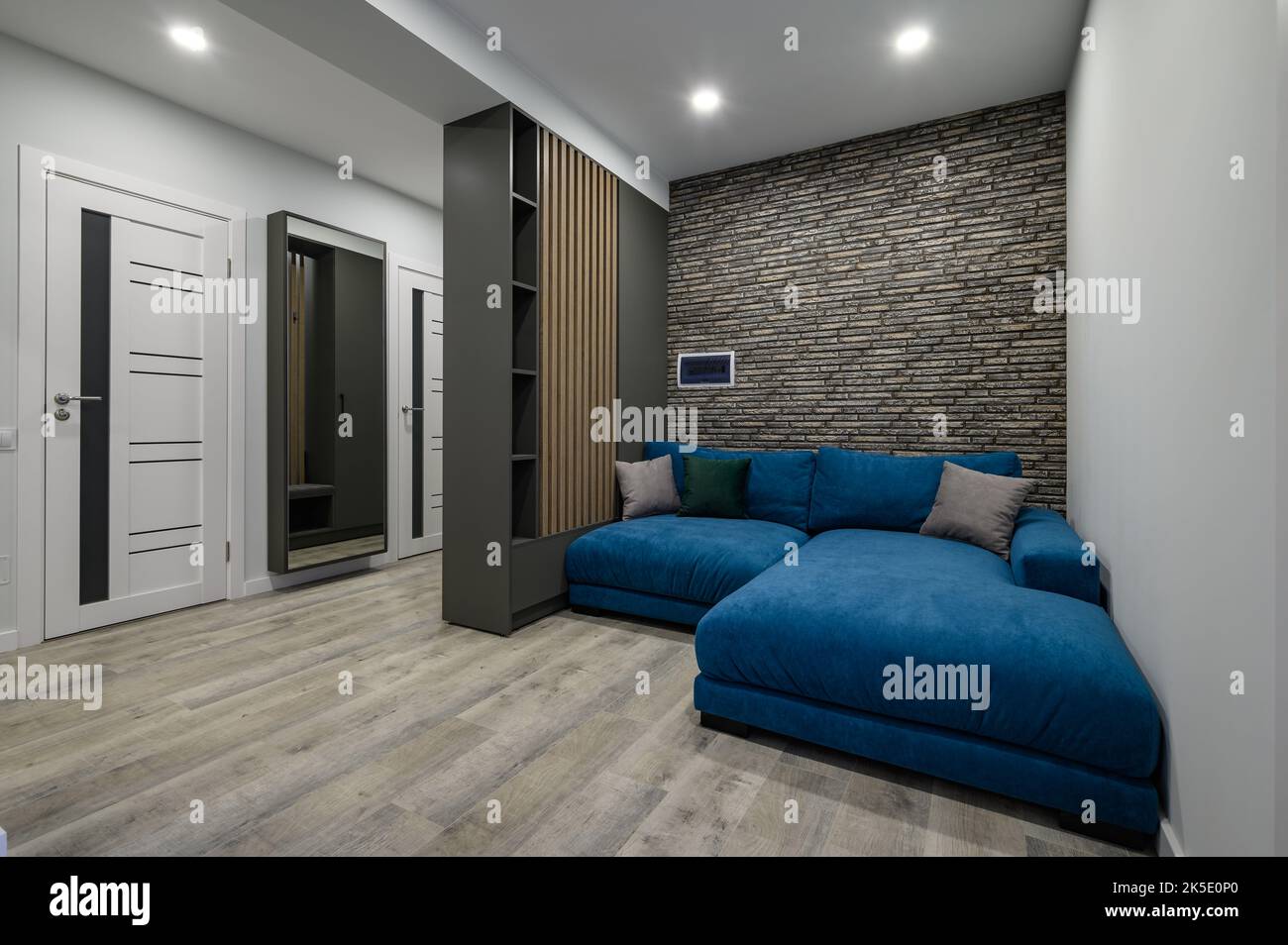 Big blue comfortable couch in modern living room and hall Stock Photo ...