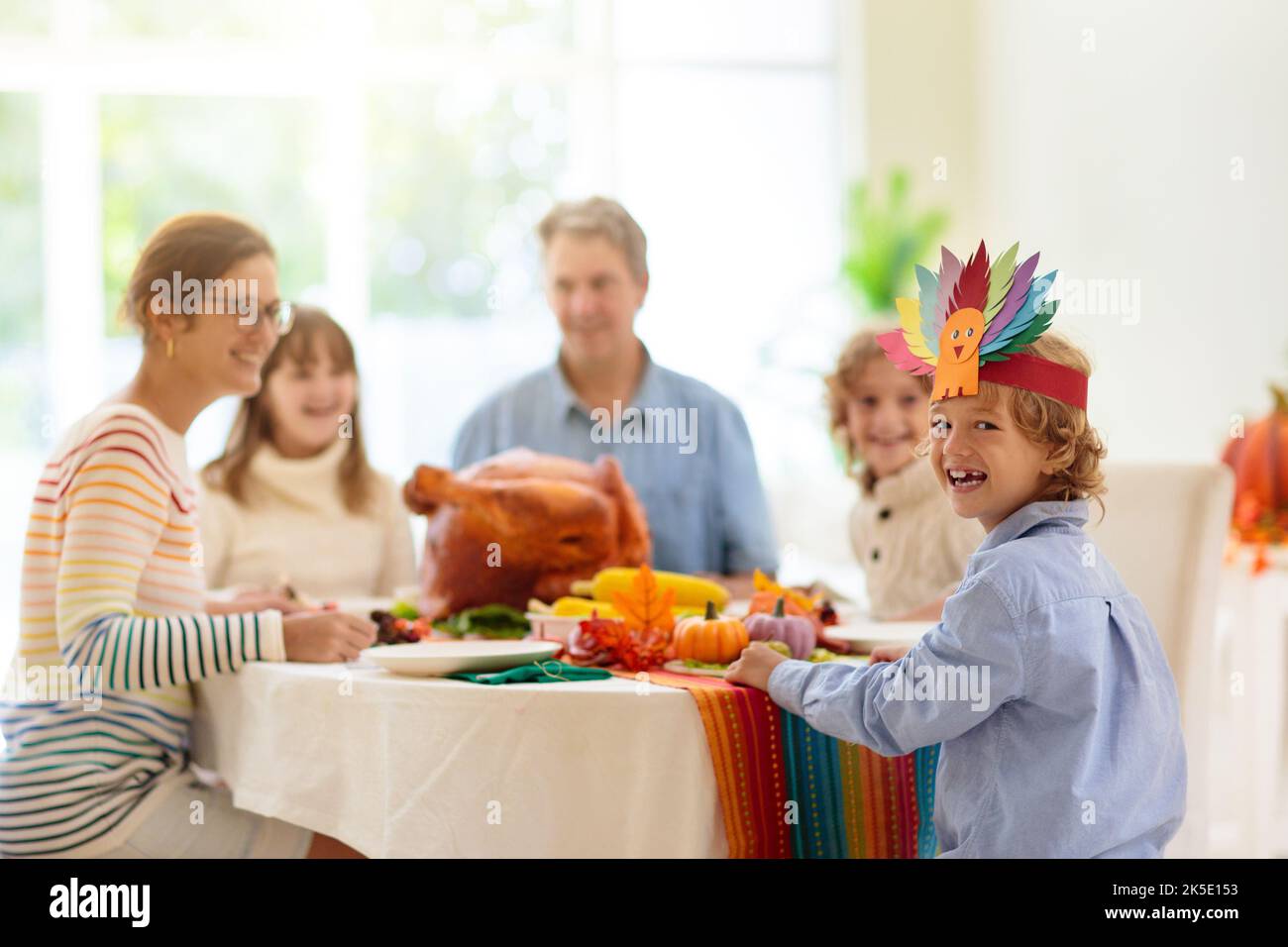 Family at Thanksgiving dinner. Parents and kids enjoy roasted turkey ...