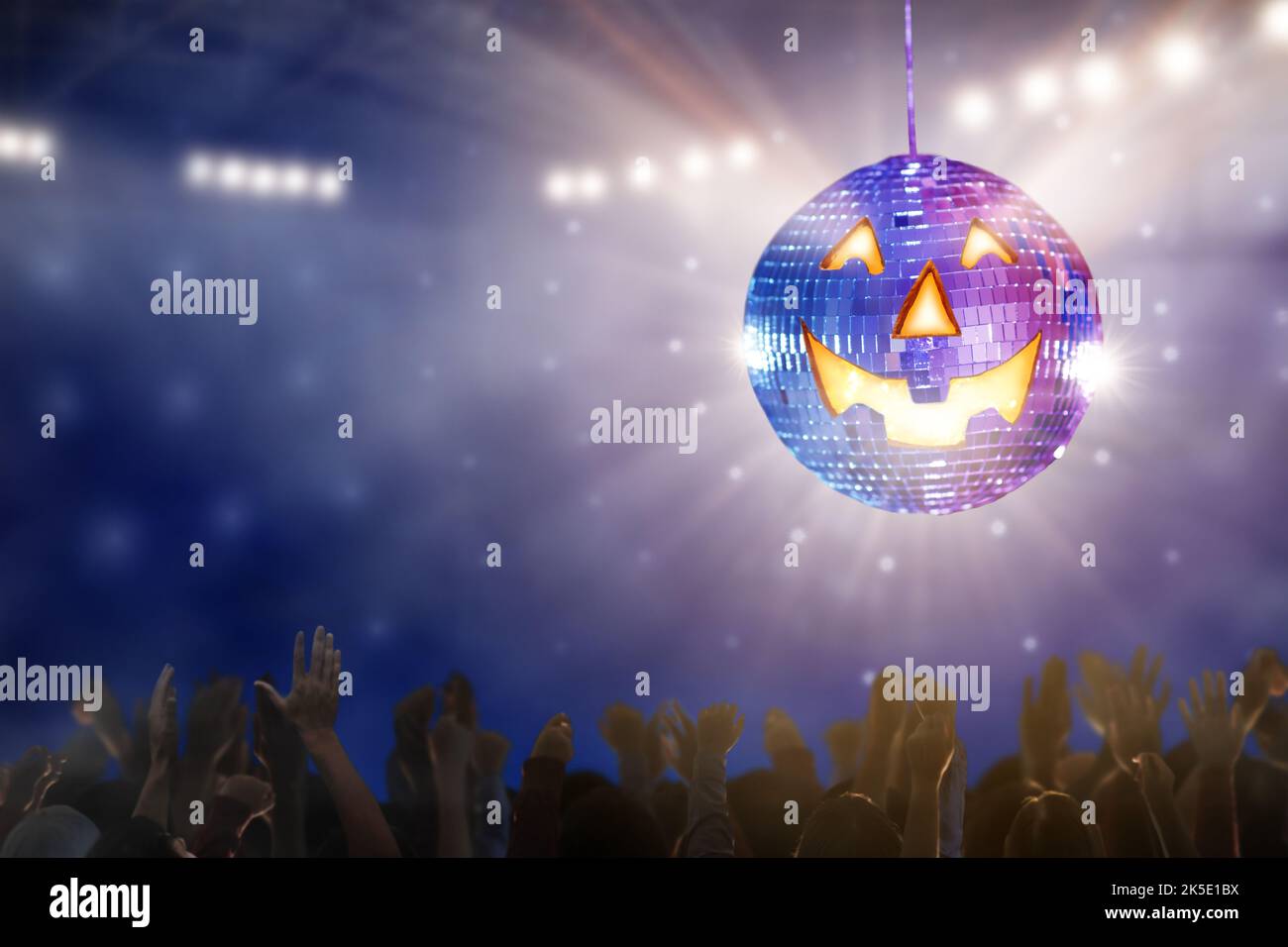 Halloween disco party in a night club. Glowing jack lantern disco ball ...