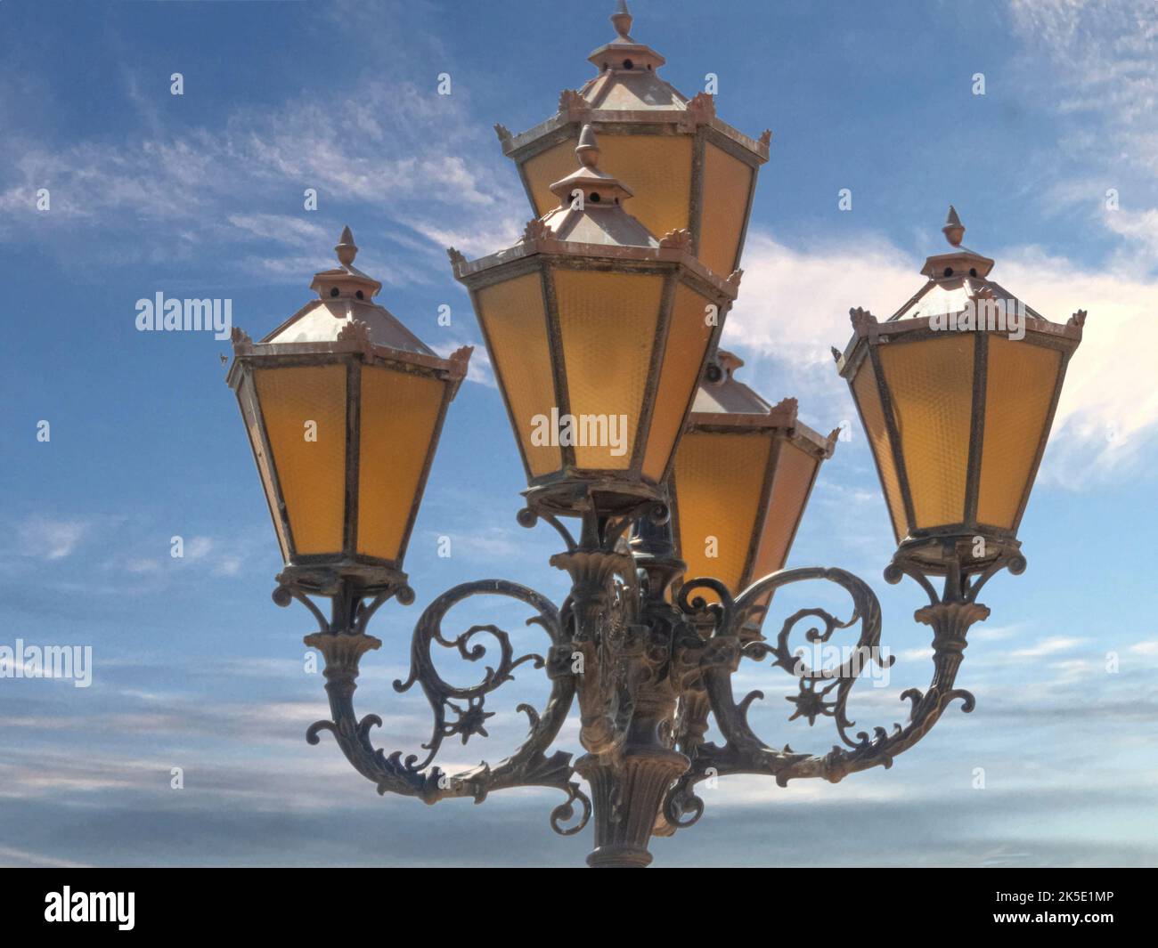 old ornate streetlight with unique scrolls against a blue sky Stock ...