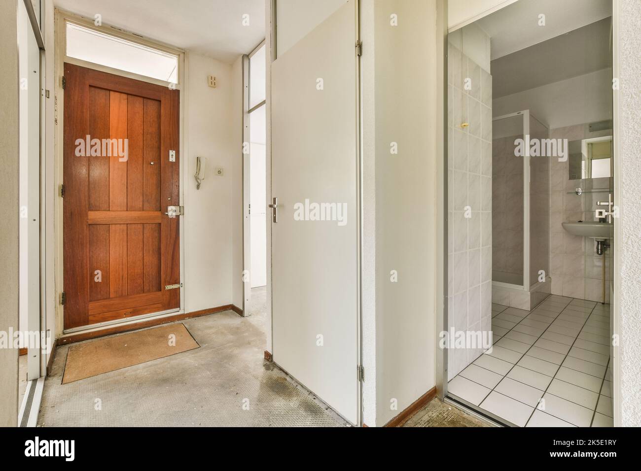 Light narrow hallway with many doors in white walls Stock Photo - Alamy