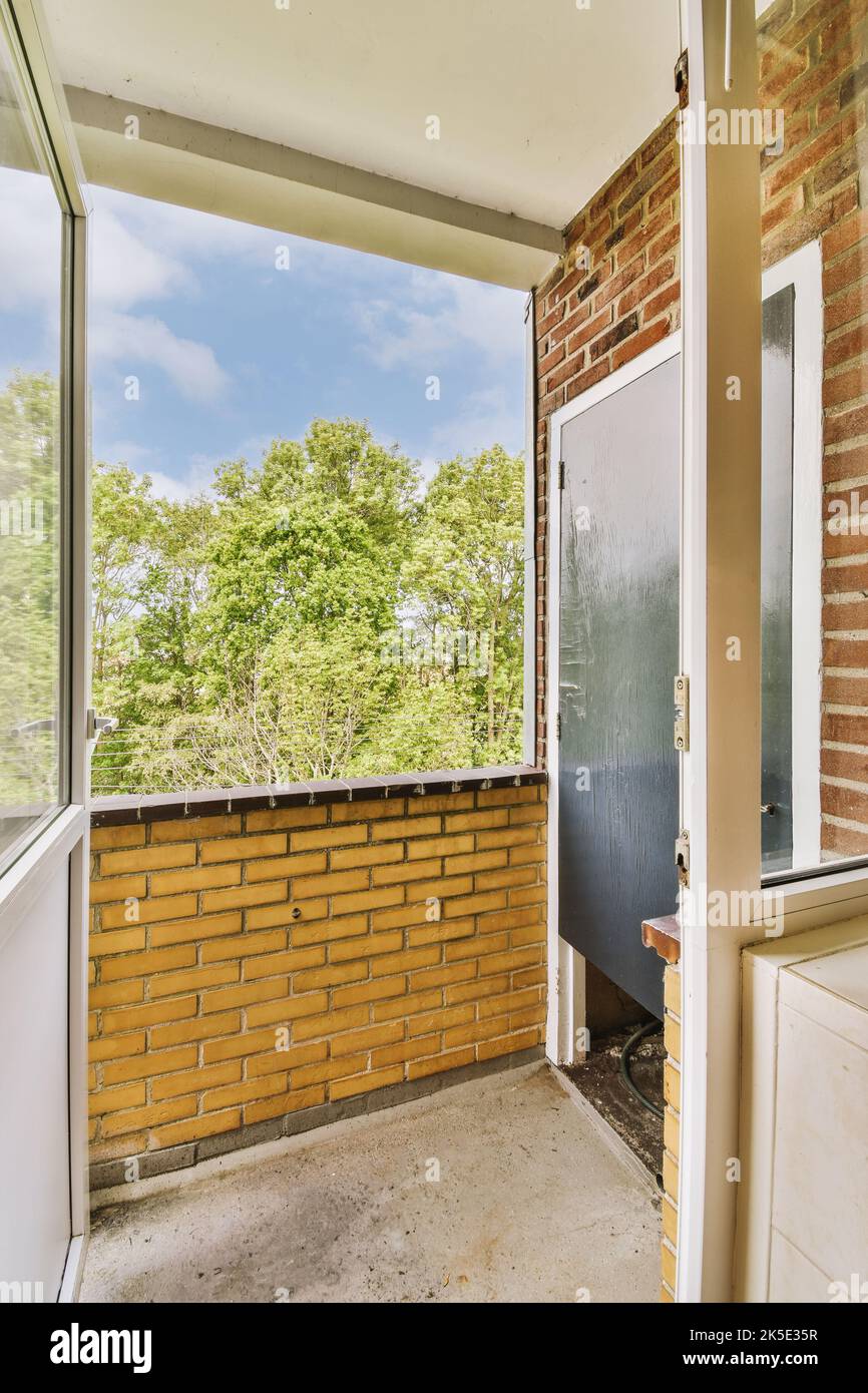 Narrow brick balcony with metal railings and door Stock Photo - Alamy