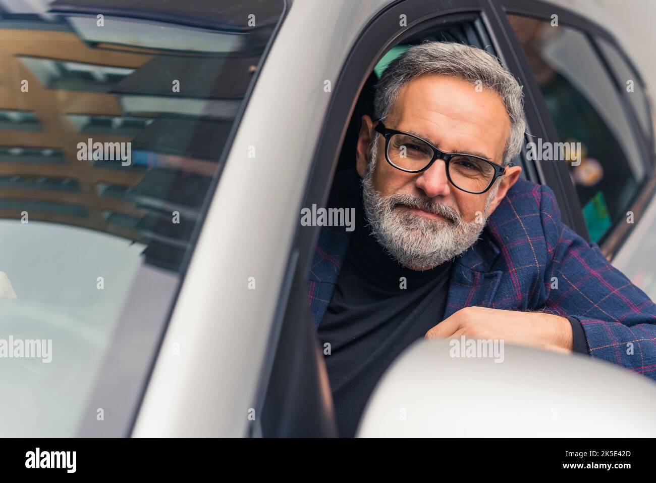 Car and commuting. Friendly caucasian male taxi driver in his 60s ...