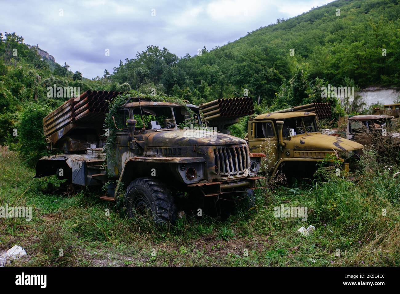 Old abandoned rusty military trucks overgrown by plants Stock Photo - Alamy