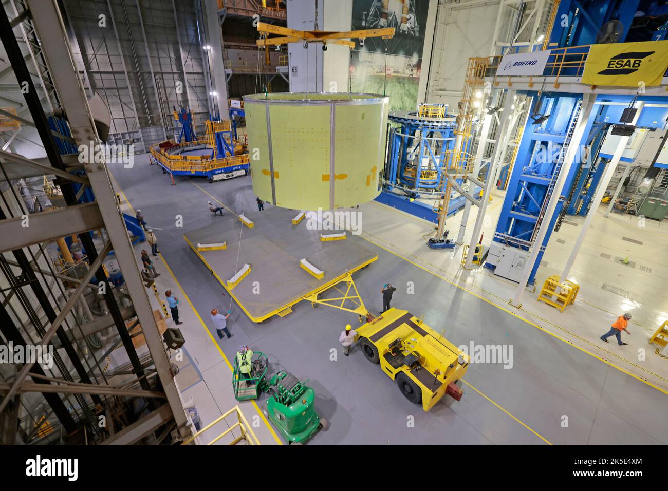 Technicians at NASA’s Michoud Assembly Facility move the engine section ...