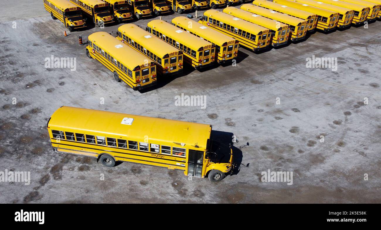 In this photo taken using a drone, school buses are seen in a lot in ...