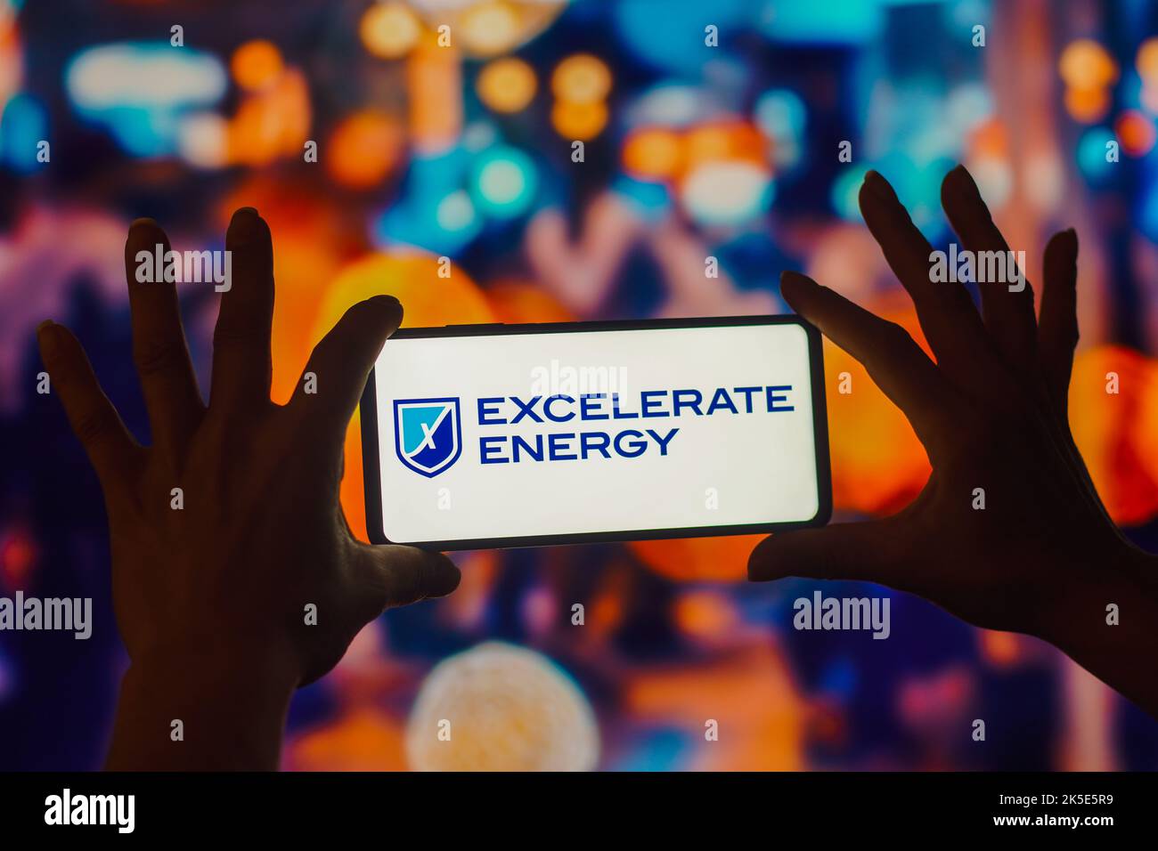 In this photo illustration, the Excelerate Energy logo is displayed on a smartphone screen Stock ...