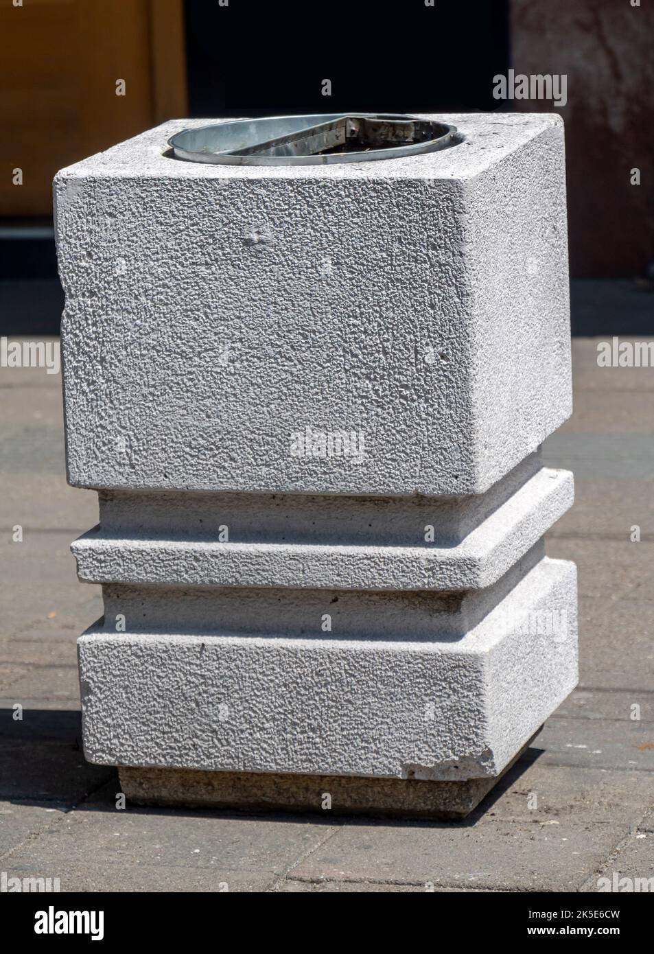 Modern stone trash bin on urban street pavement Stock Photo - Alamy