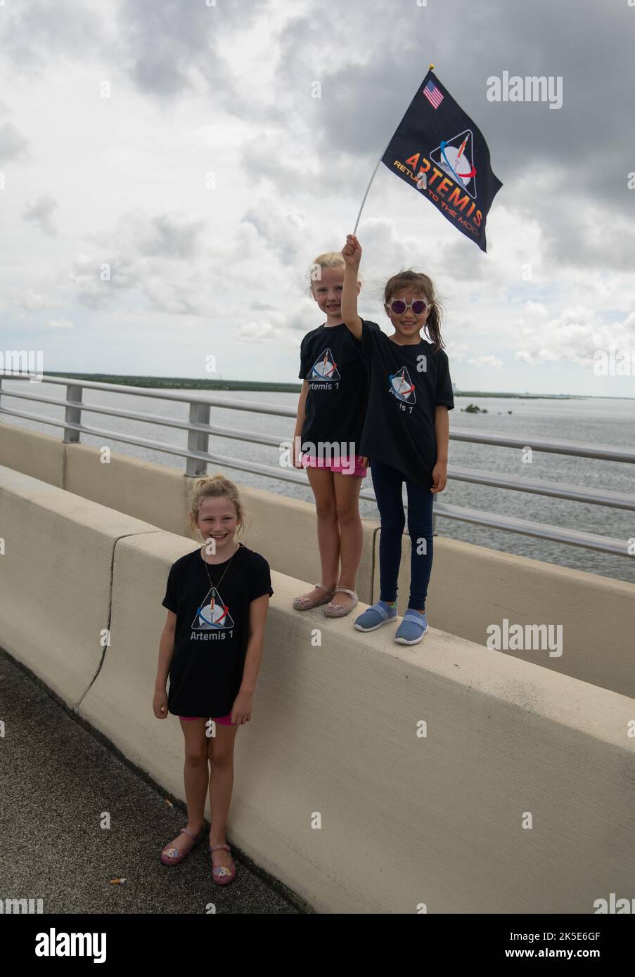 A group of young children with an Artemis flag are photographed on the ...