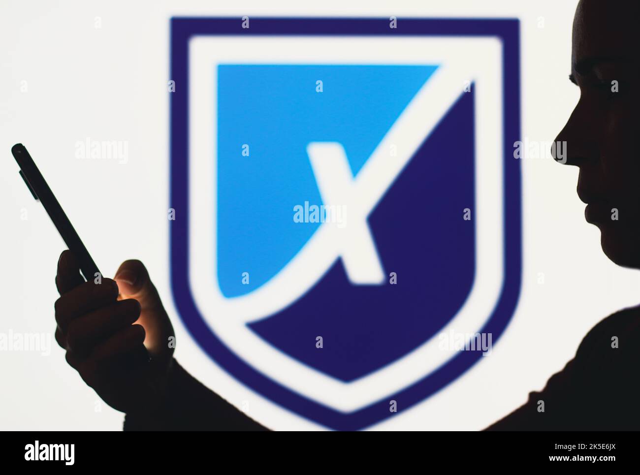 In this photo illustration, a woman's silhouette holds a smartphone ...