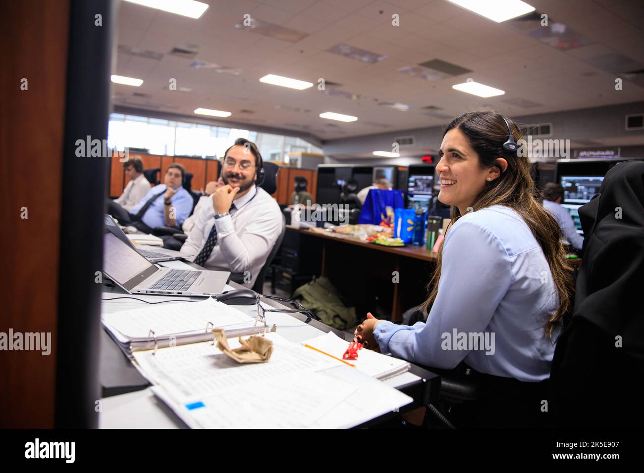 Members of the Artemis I launch team are at their consoles inside ...