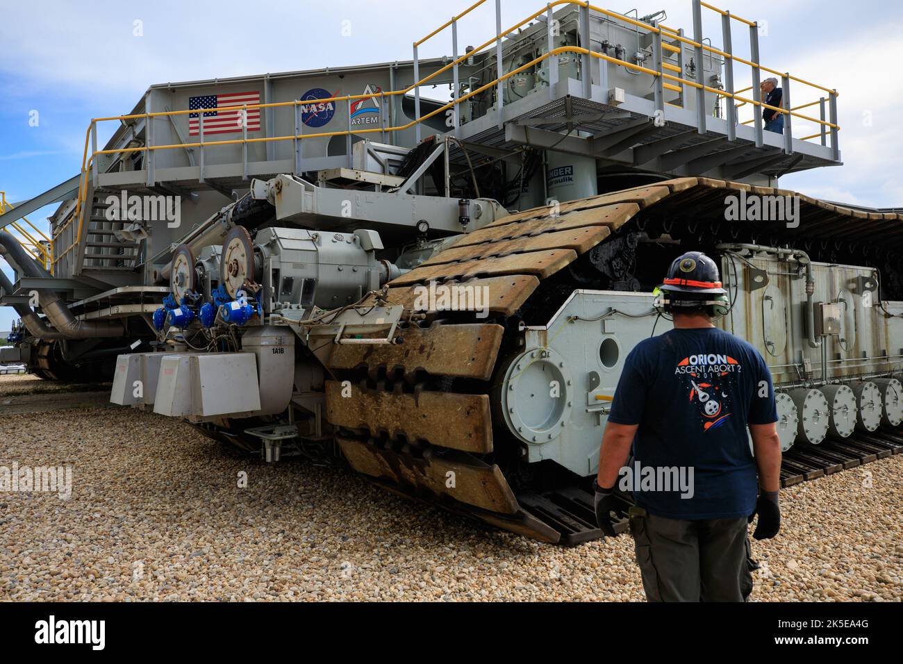 A technician checks the giant tracks crawler-transporter 2 during its ...