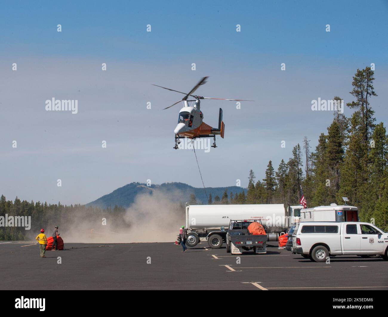 A Kaman "KMAX" firefighting helicopter lifts off from Crescent Lake ...
