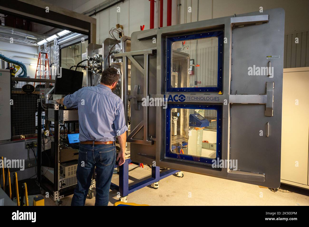 Engineer Matt Nugent prepares a vacuum chamber for testing 3D printing ...
