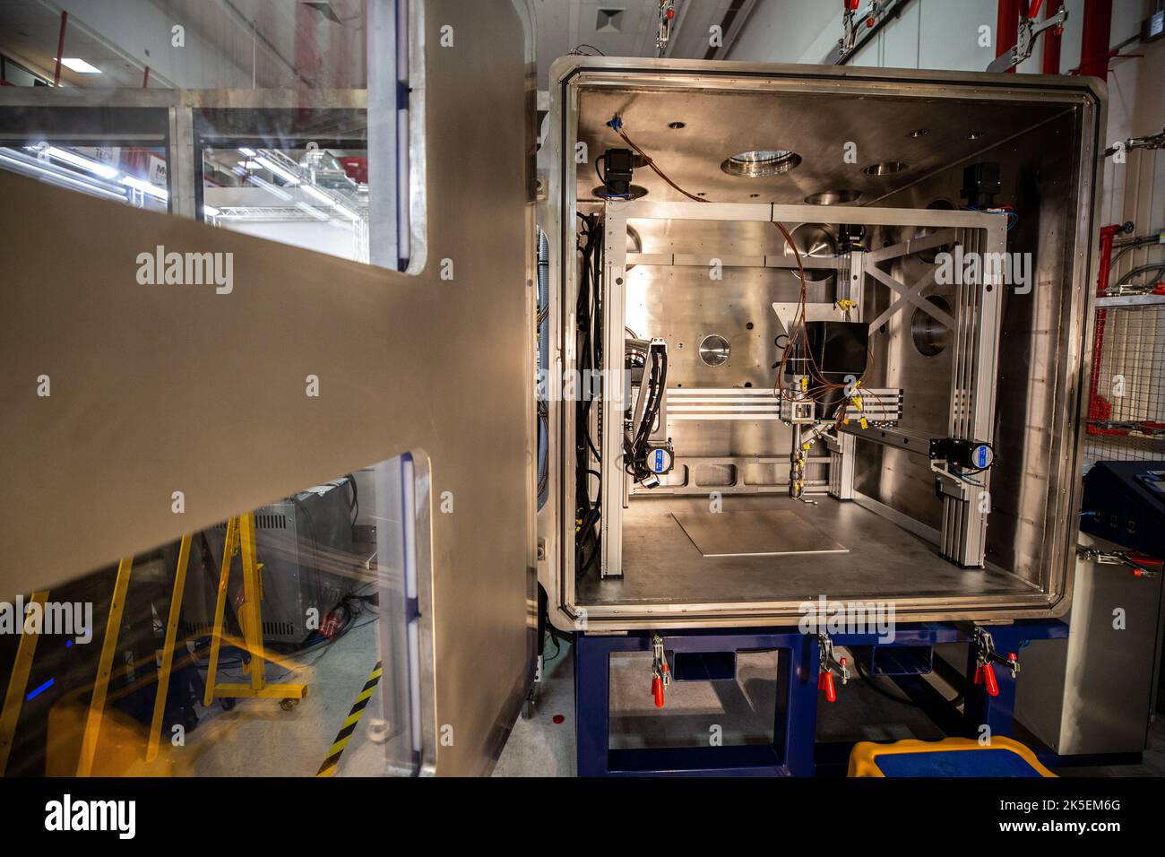 A team of engineers and researchers prepares a vacuum chamber in the ...