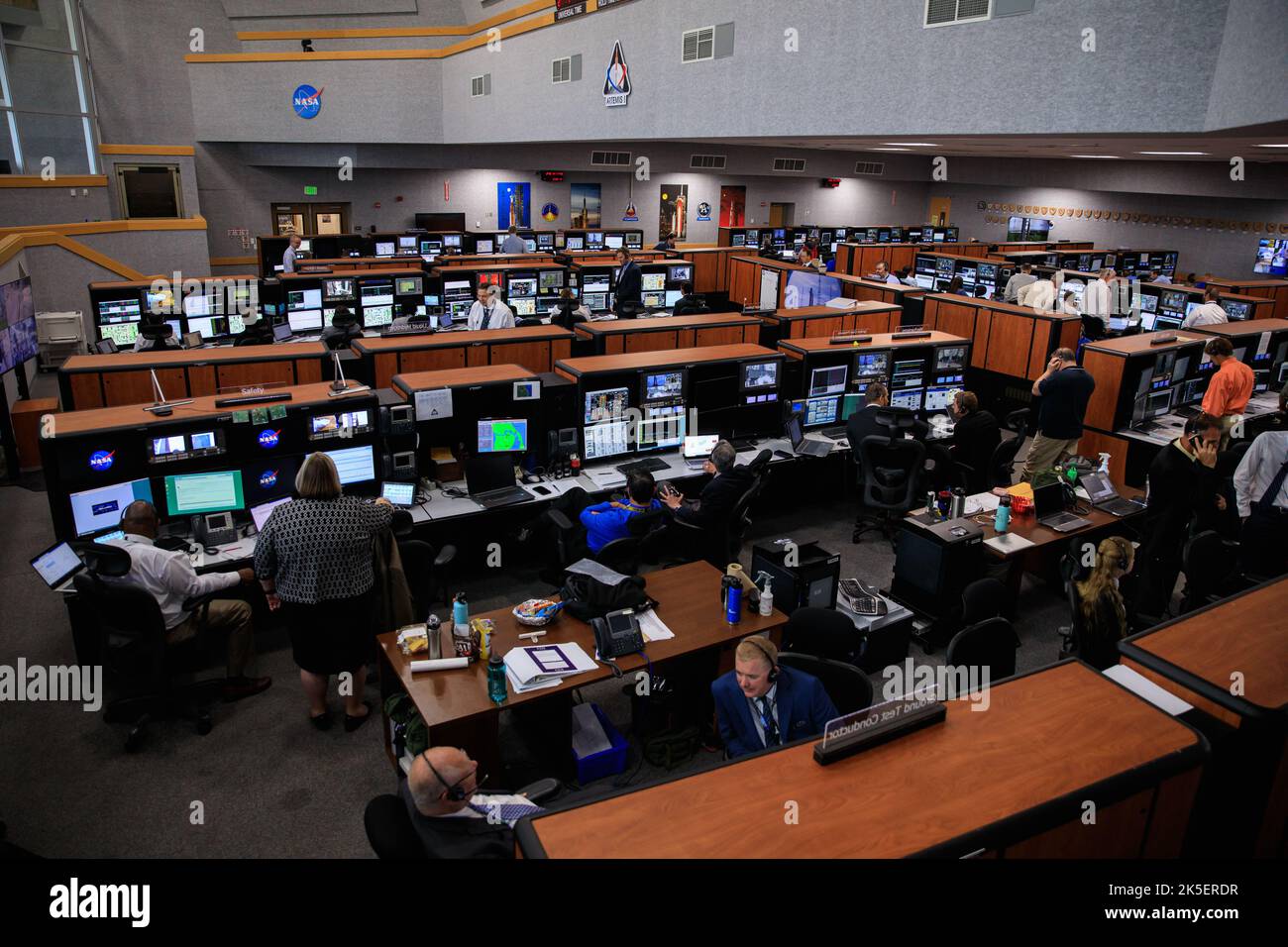 Members of the Artemis I launch team are at their consoles inside ...