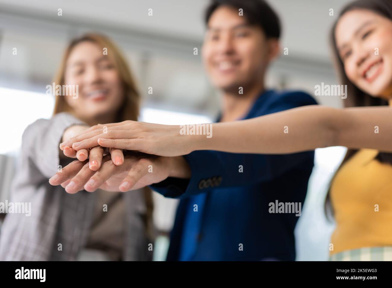 Group of Asia young entrepreneurs creative people join hand and excited ...