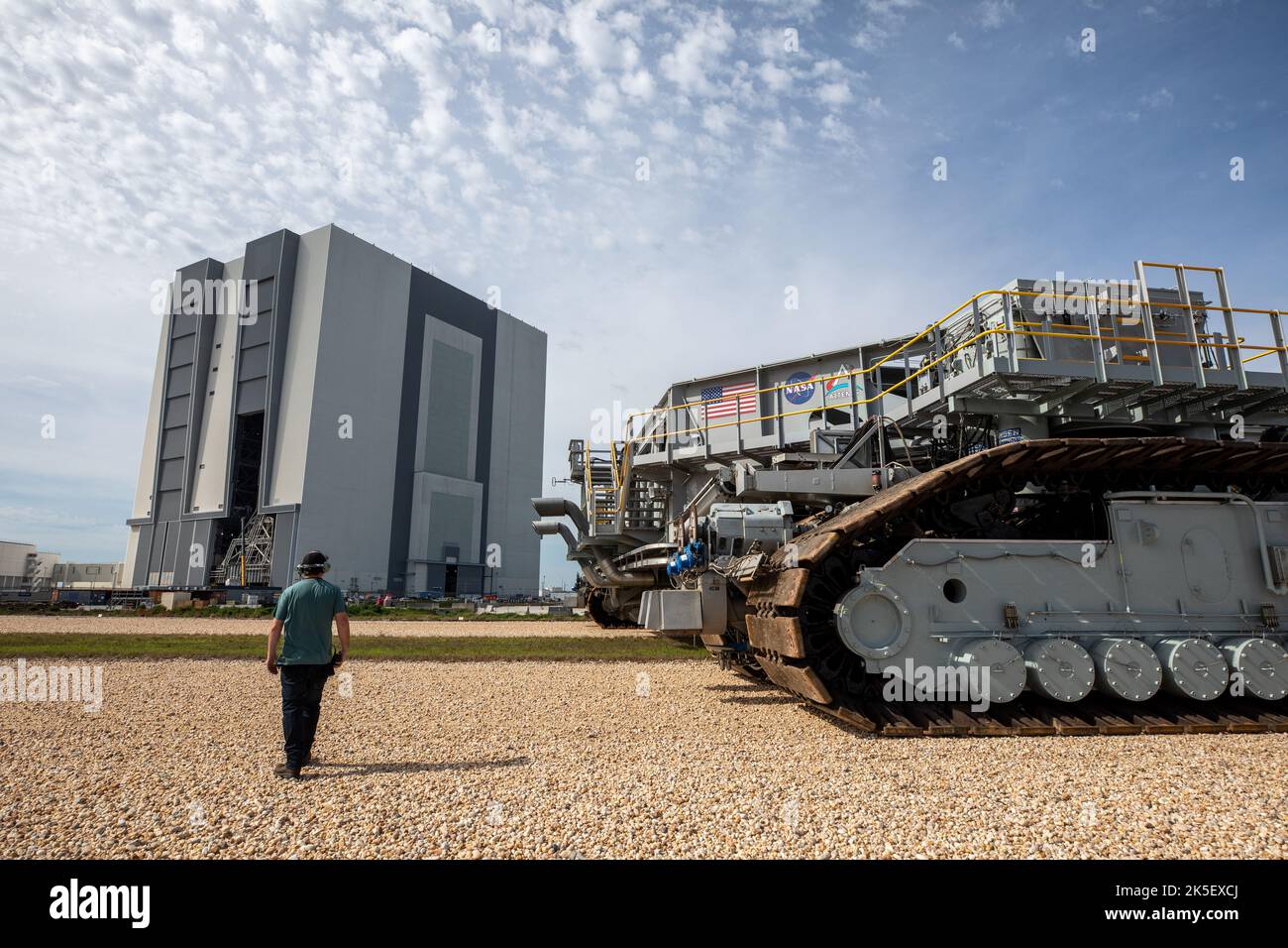 Engineers and technicians drive the crawler-transporter 2 along the ...