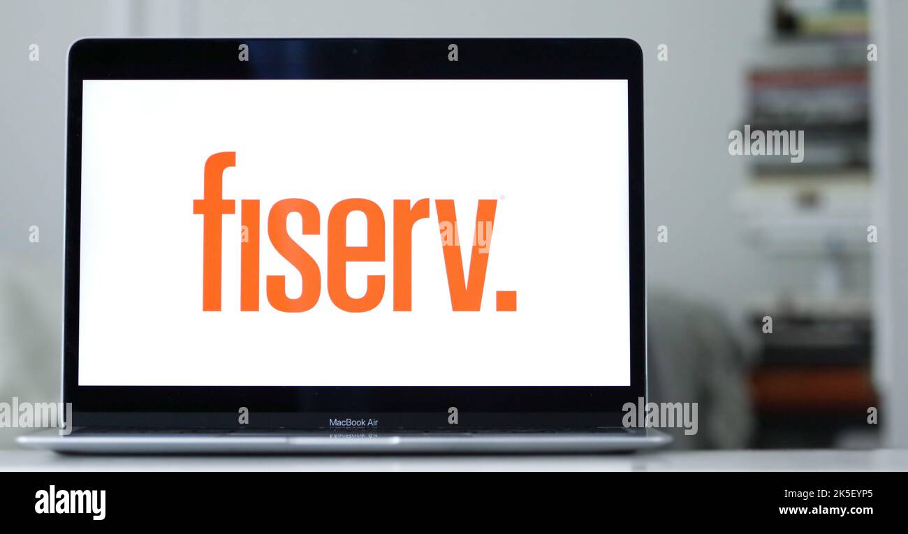 A laptop sceeen displaying the logo of Fiserv, a global financial ...